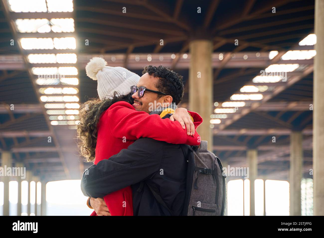 Smiling tourists embracing joyfully after arriving at their destination ...