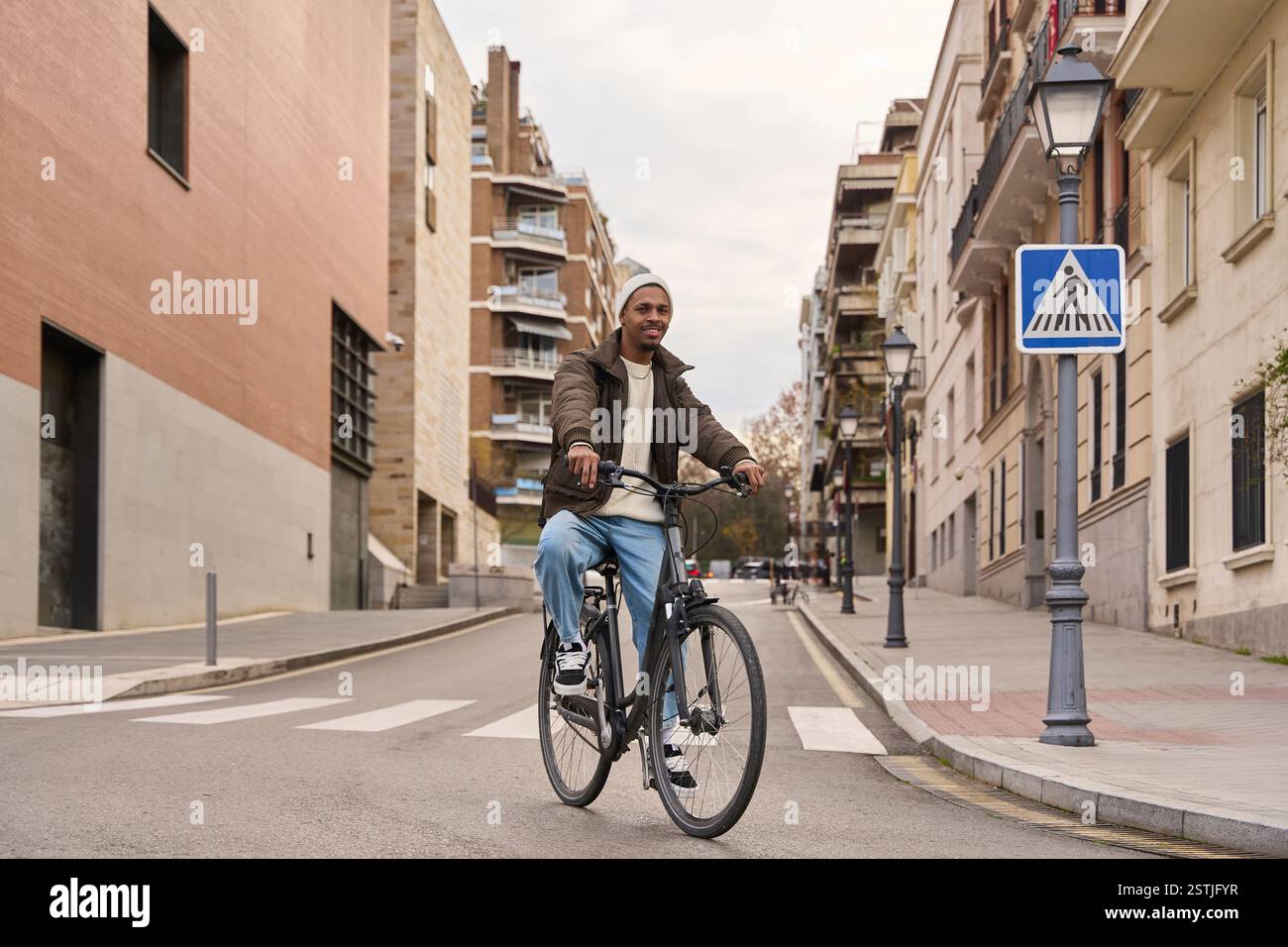 Stylish man enjoying a bike ride in the city, promoting sustainable and ...