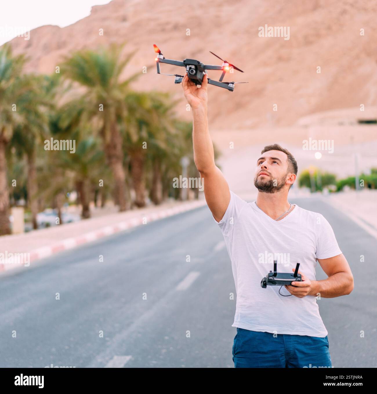 Young man holding drone before flight at nature Stock Photo - Alamy