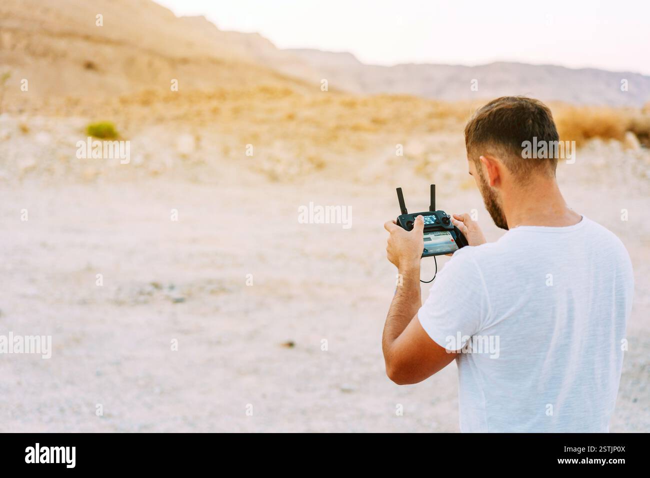 Guy controls drone with remote control Stock Photo - Alamy