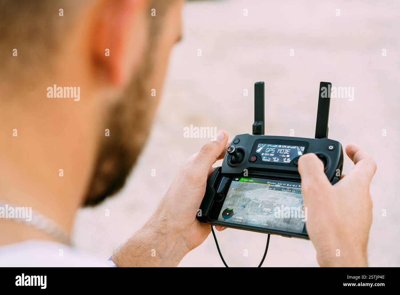 Guy controls drone with remote control Stock Photo - Alamy