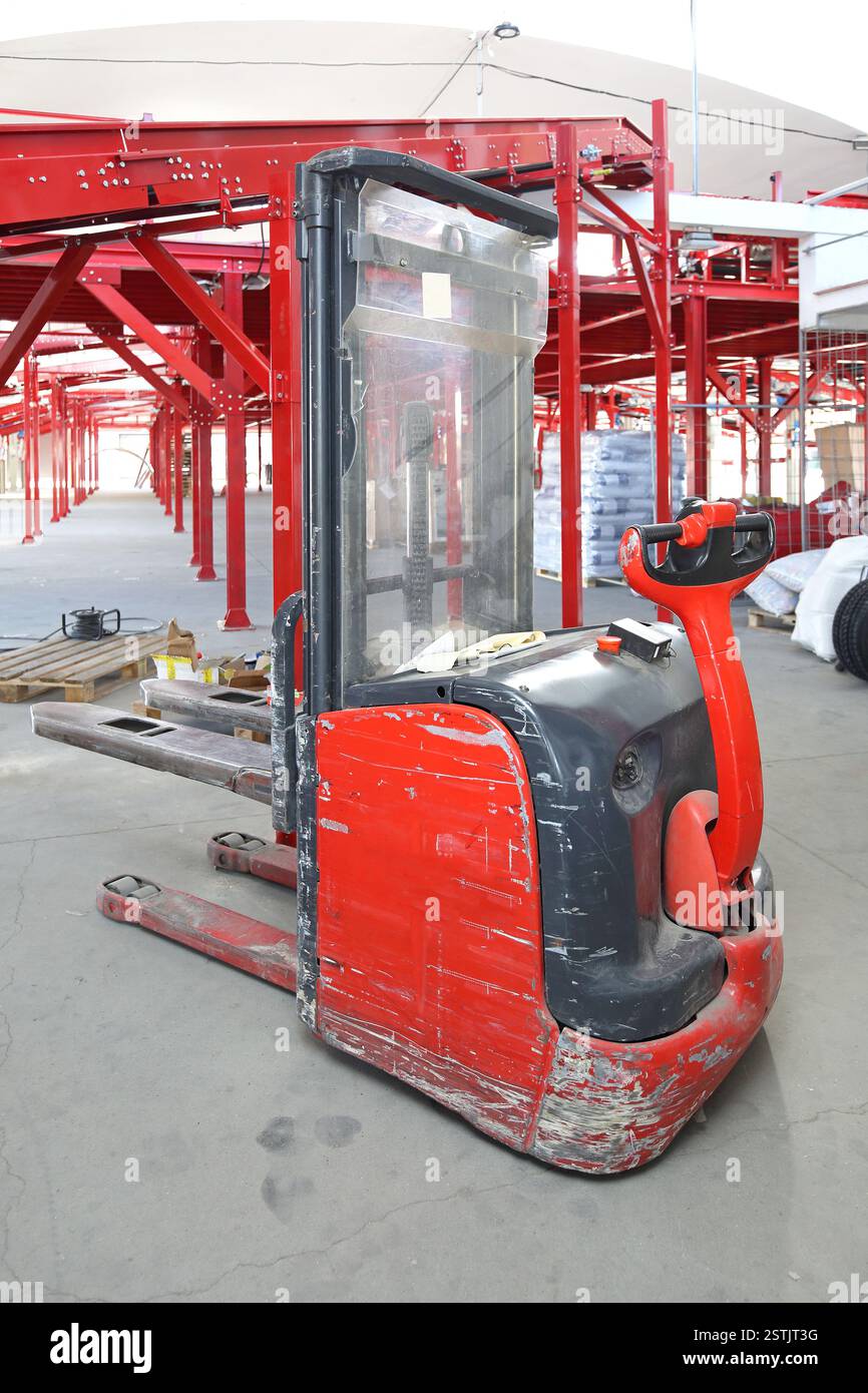 Electric forklift truck stacker in distribution warehouse hi-res stock ...