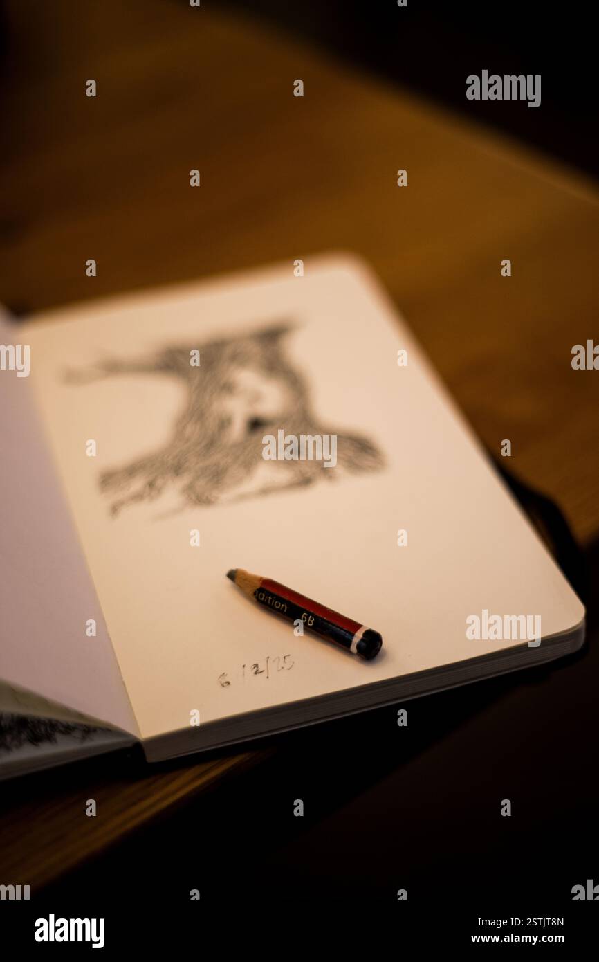 Little pencil and sketchbook on a desk Stock Photo - Alamy