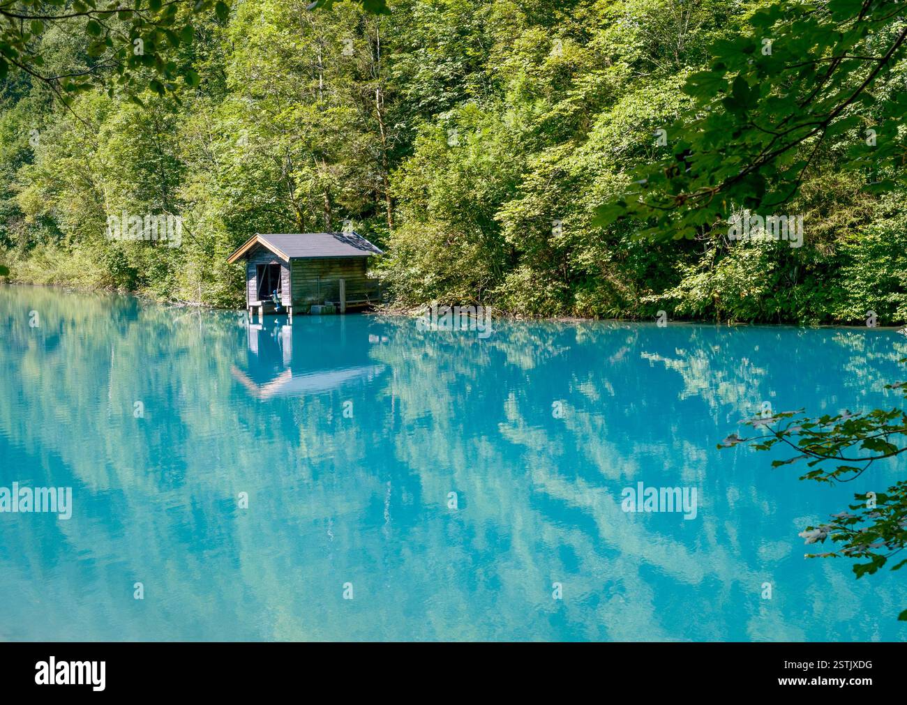 Turquoise waters of Klammsee Lake in Kaprun, Austria with small rustic ...