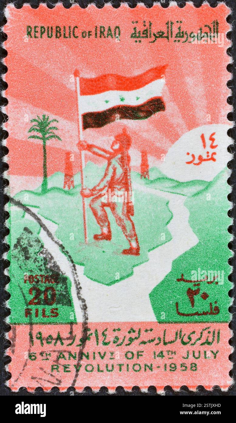 Cancelled postage stamp printed by Iraq, that shows Soldier raising ...