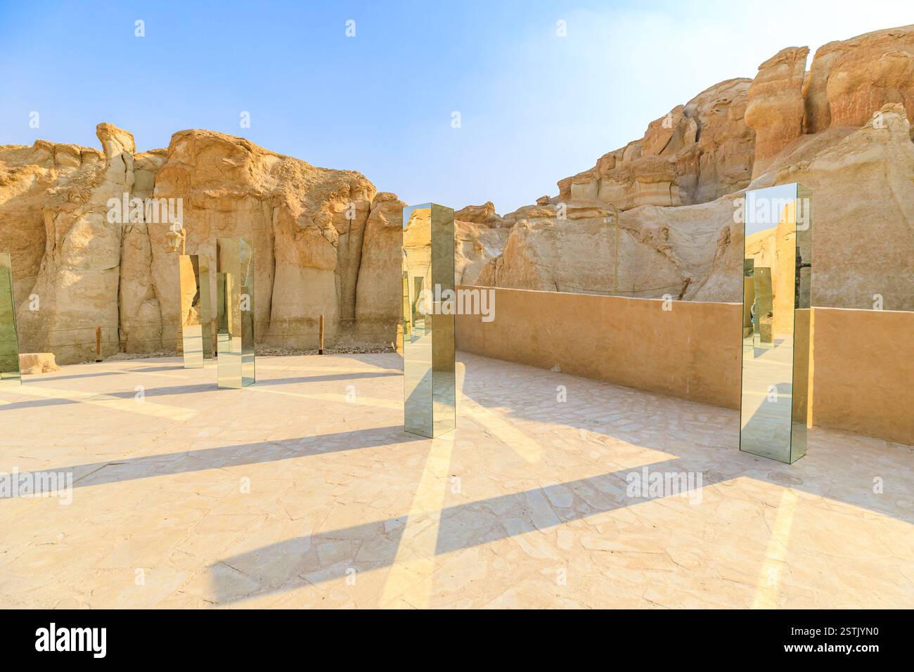 Large mirrors reflecting the rock caves of Jabal Al Qarah mountain, a ...