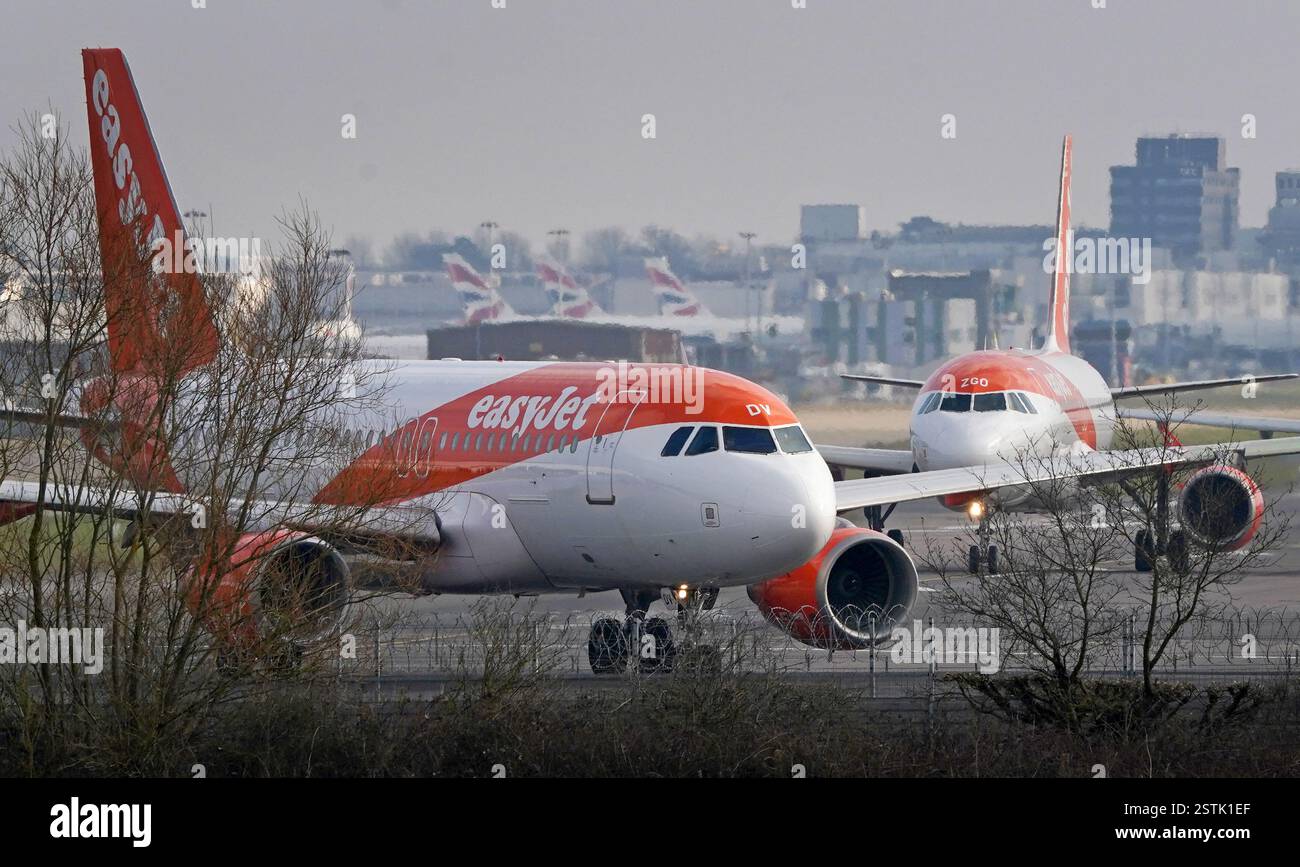 EasyJet planes queue for take off at London Gatwick Airport in Crawley, West Sussex. Gatwick ...