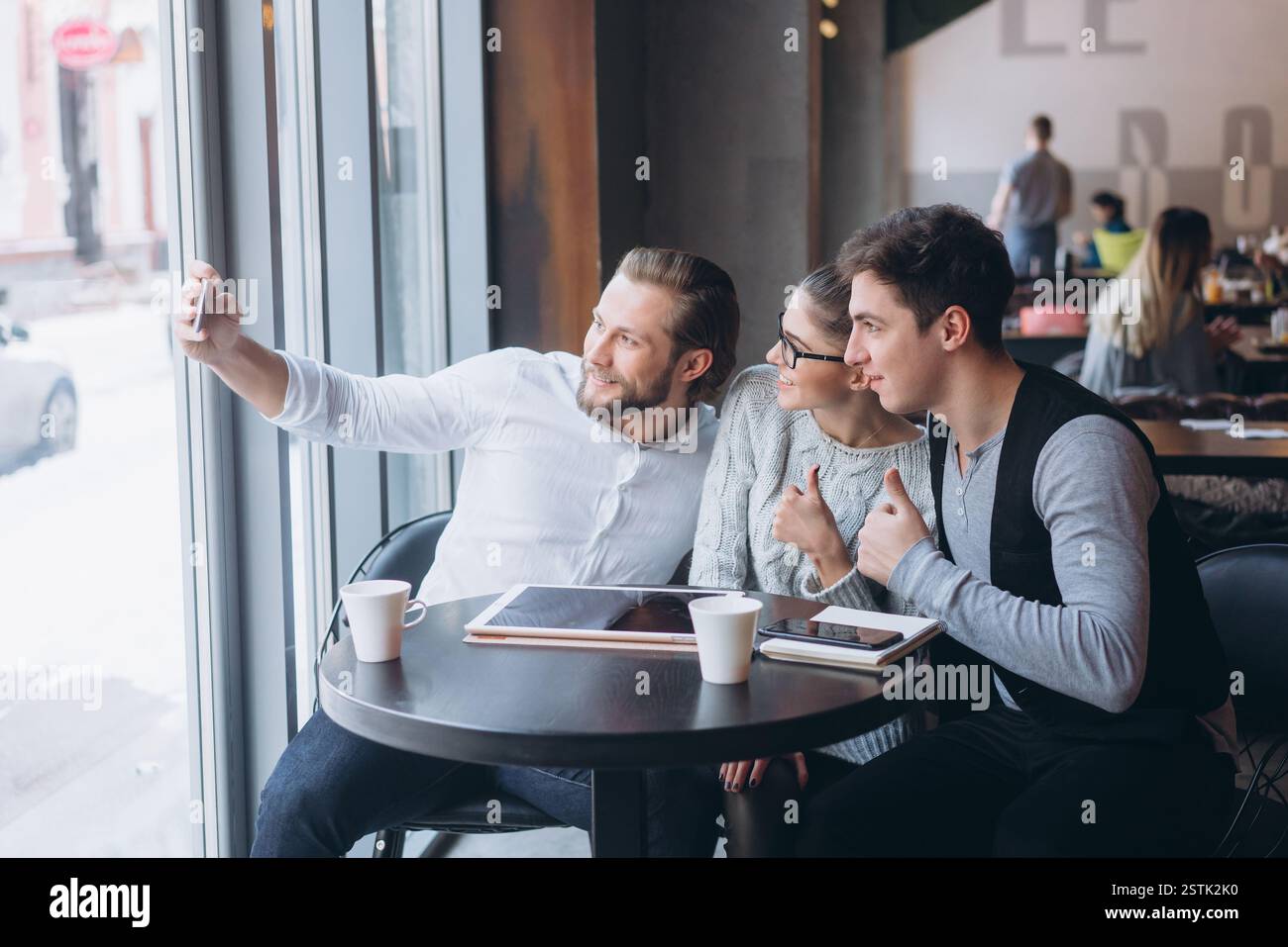 Three successful business people taking Selfie Stock Photo - Alamy