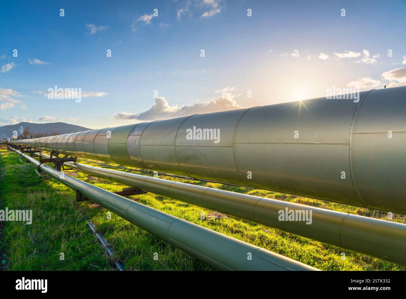 Pipelines of a geothermal power plant at sunset in Larderello, Tuscany ...