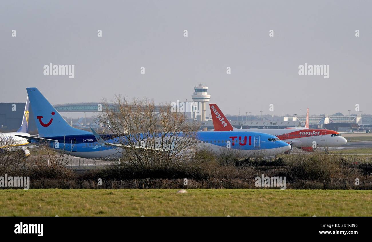 A TUI and EasyJet plane queue for take off at London Gatwick Airport in ...