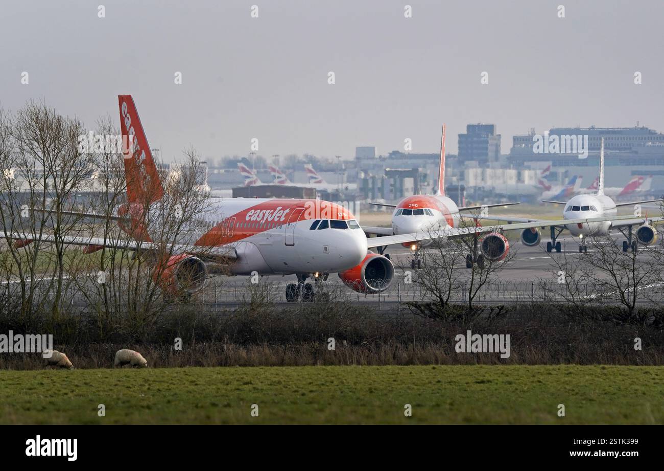 EasyJet planes queue for take off at London Gatwick Airport in Crawley, West Sussex. Gatwick ...