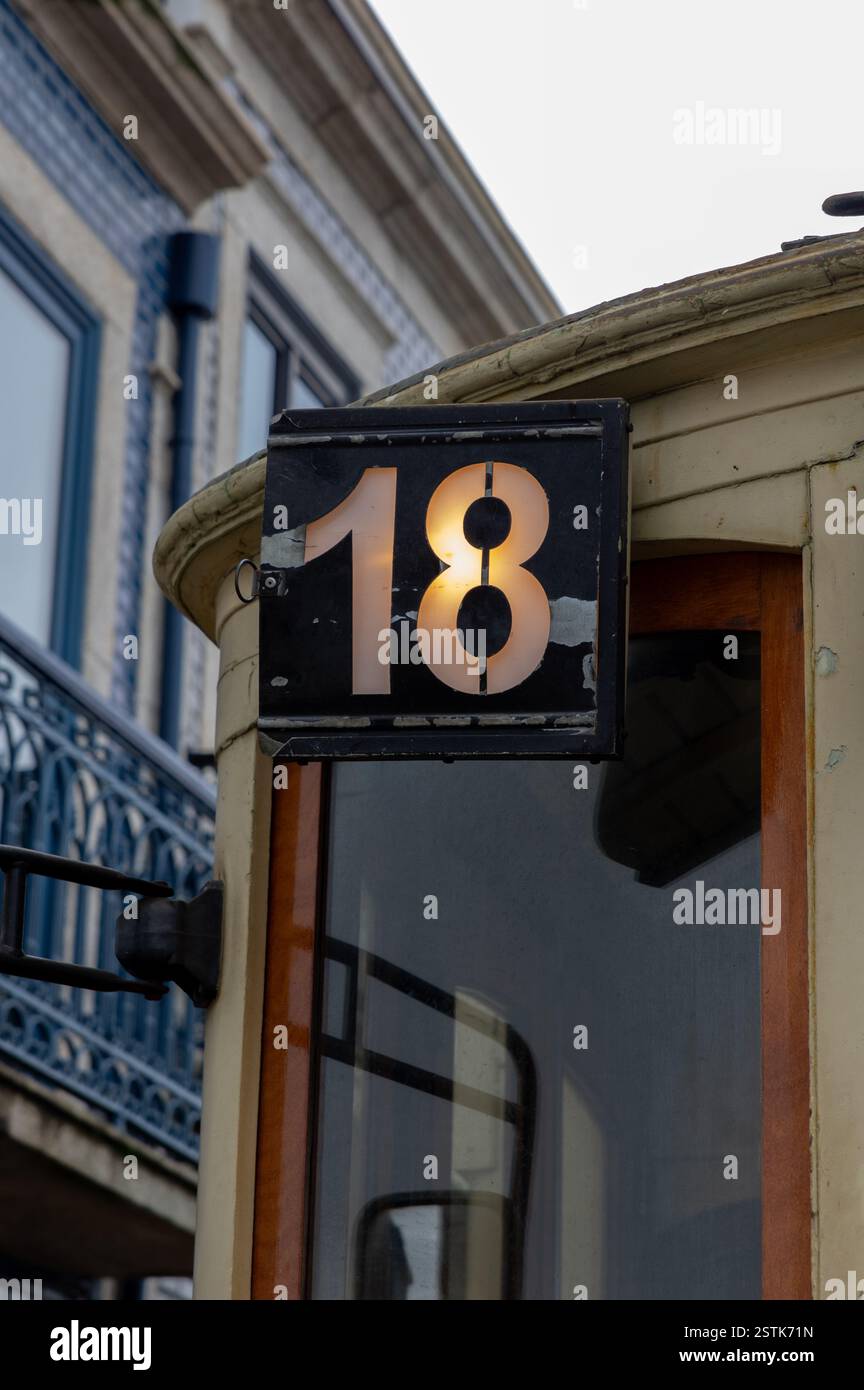 Illuminated number 18 on O Porto Portugal tram with house with typical ...