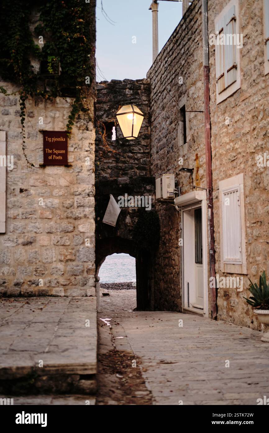 Quiet alleyway in a historic European town, lined with rustic stone ...