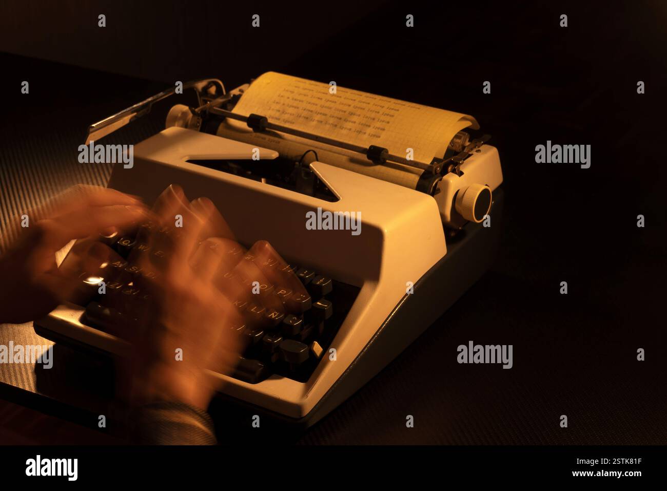 Blurred hands typing on a retro white typewriter in a dark moody ... Blurred hands typing on a retro white typewriter in a dark moody ...