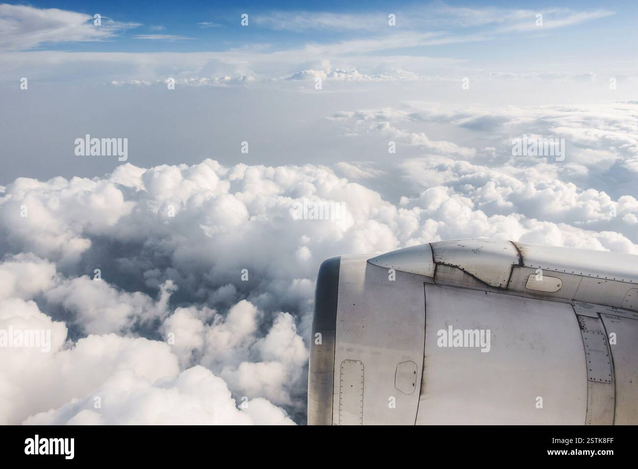 Slightly dirty airliner jet engine and cloudy sky, airplane in flight ...