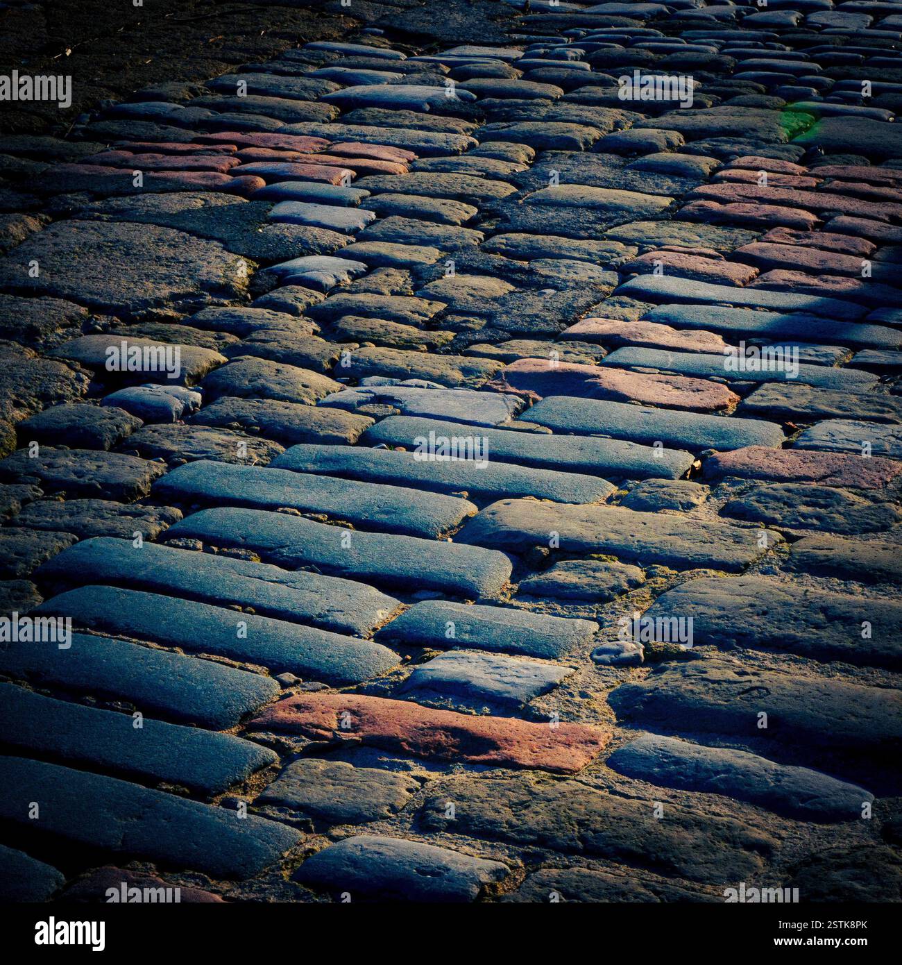 Cobblestone street on the harbour of Lyme Regis in Dorset, England, UK ...