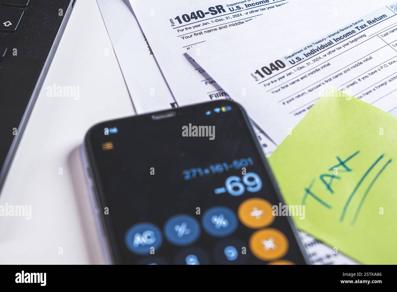 Tax form 1040, w-9, pencil, marker pen, reading glasses and laptop are ...