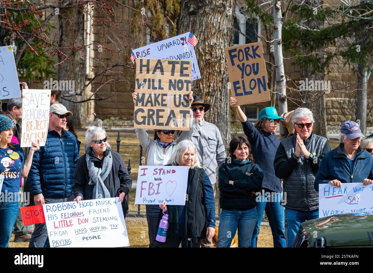 Activists stand with signs about hate, Elon Musk and the FBI at at the ...