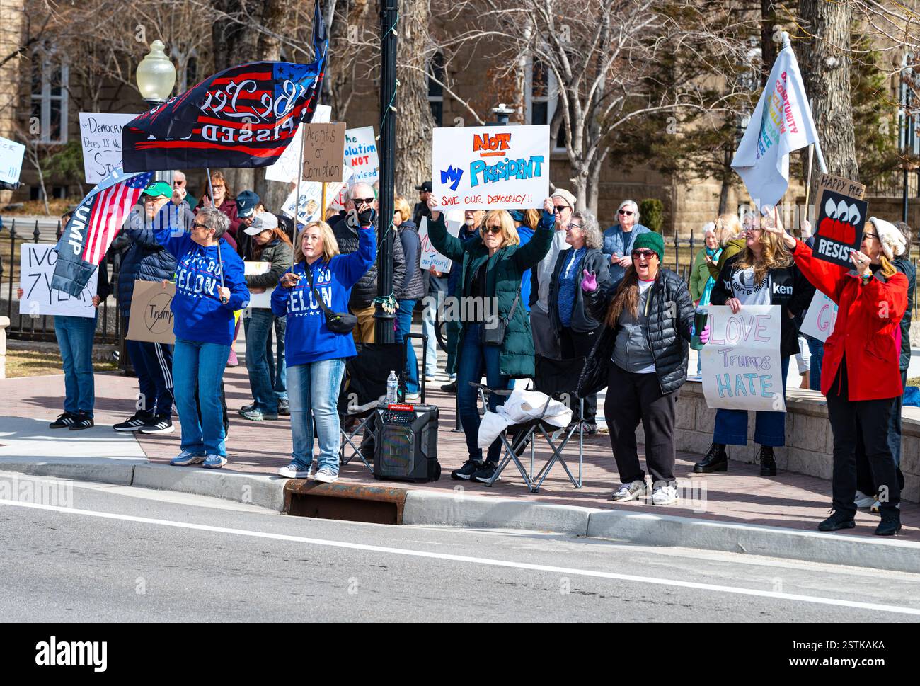A crowd of people hold various signs including Not My President at the ...