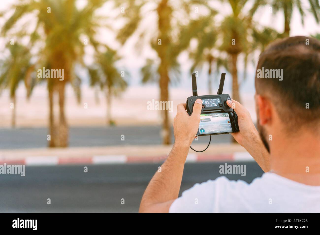 Guy controls drone with remote control Stock Photo - Alamy