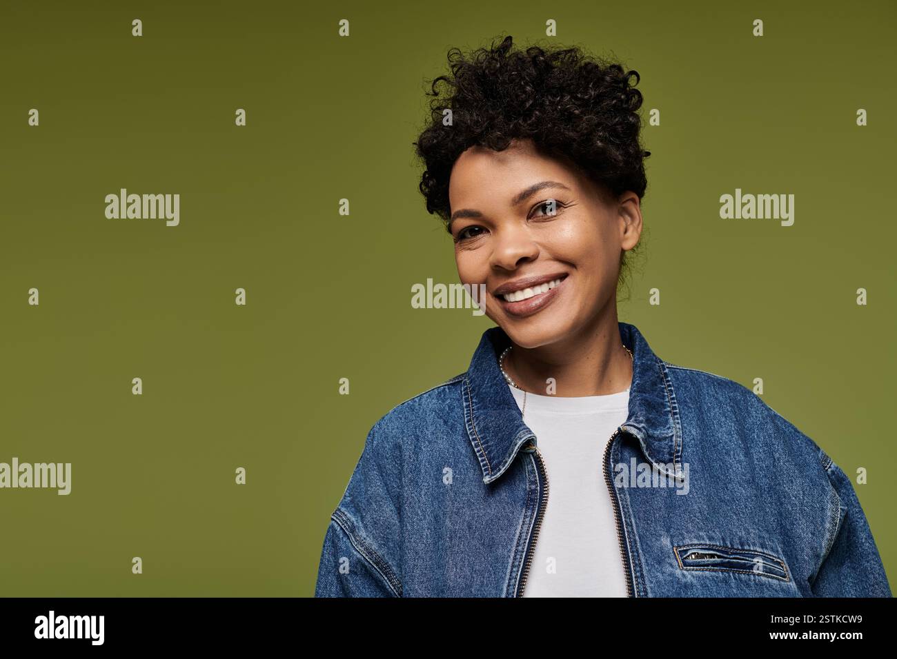 Chic woman in vibrant attire posing on green olive backdrop Stock Photo ...