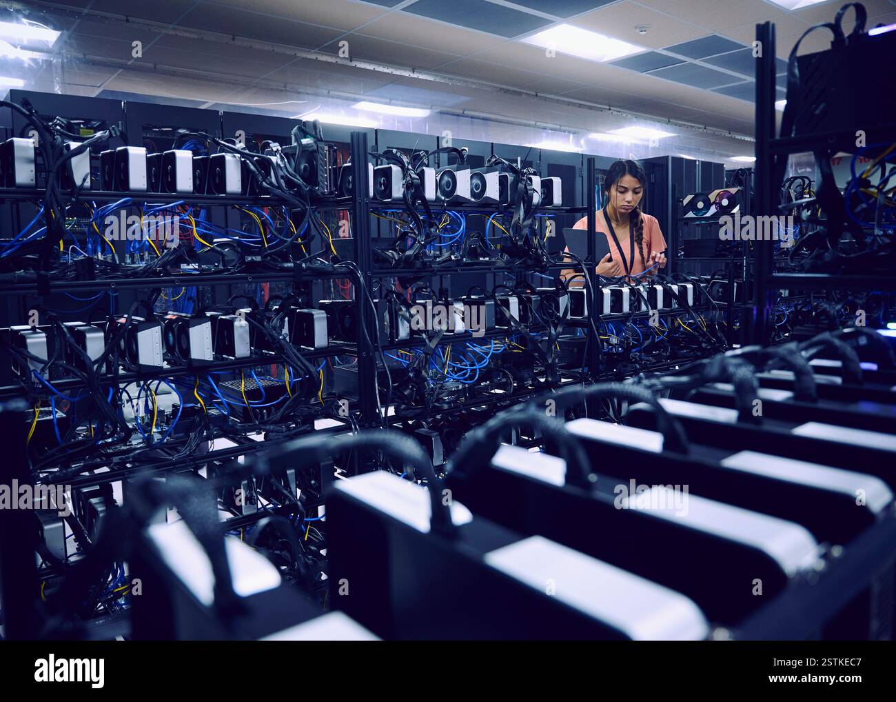 Female technician working in server room Stock Photo - Alamy