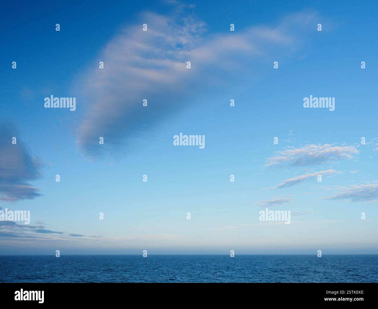 Wispy clouds above sea Stock Photo - Alamy