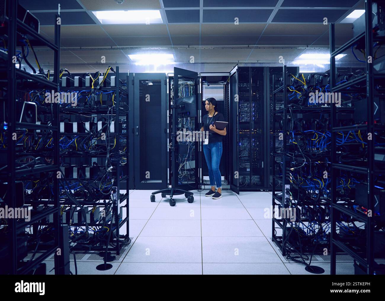 Female technician using computer in server room Stock Photo - Alamy