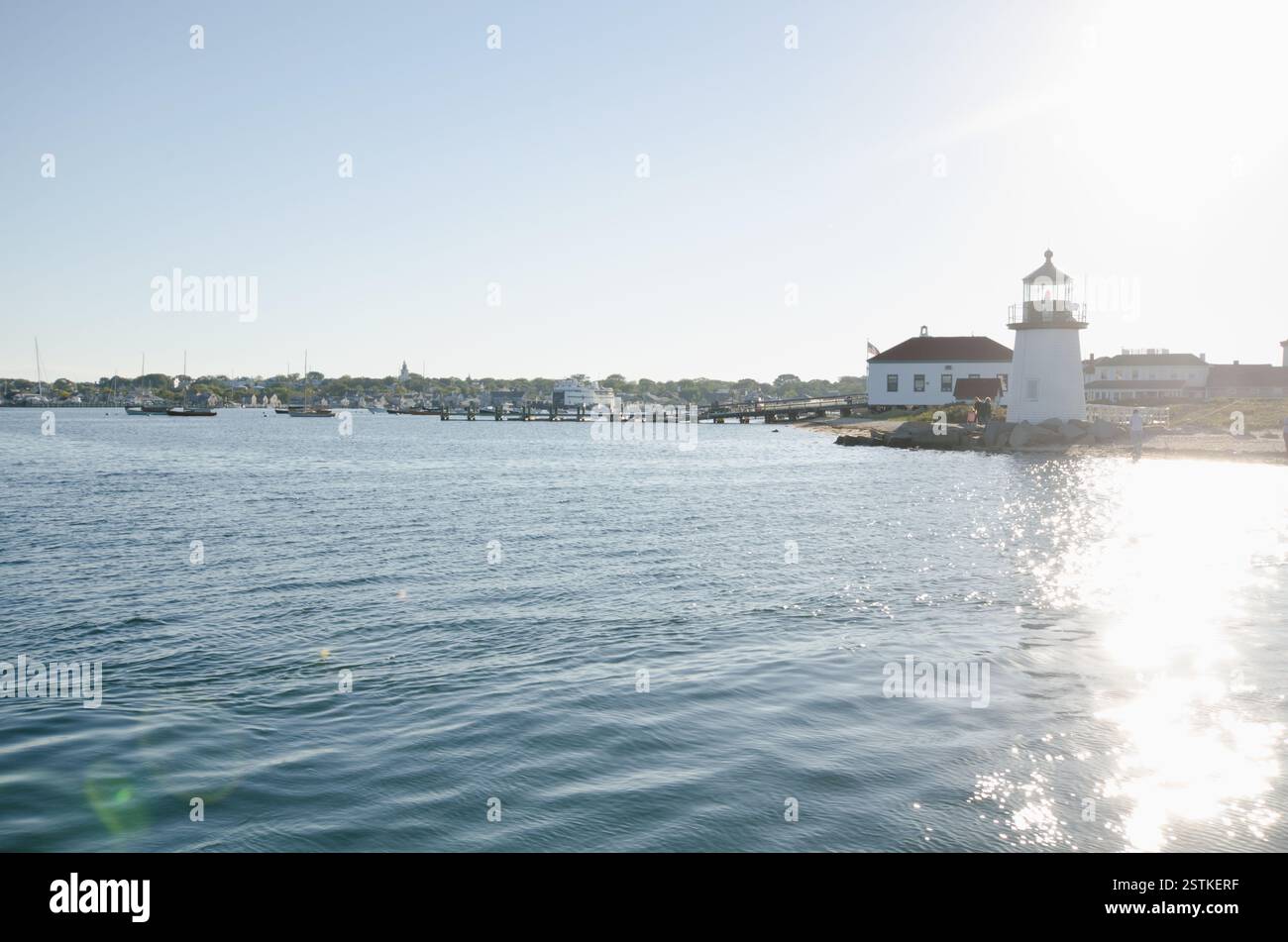 Brant Point Lighthouse and harbor with water reflecting sunlight Stock ...