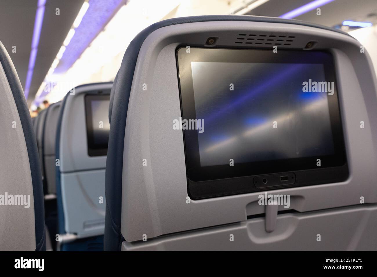 Close-up of airplane seat with individual monitor Stock Photo - Alamy