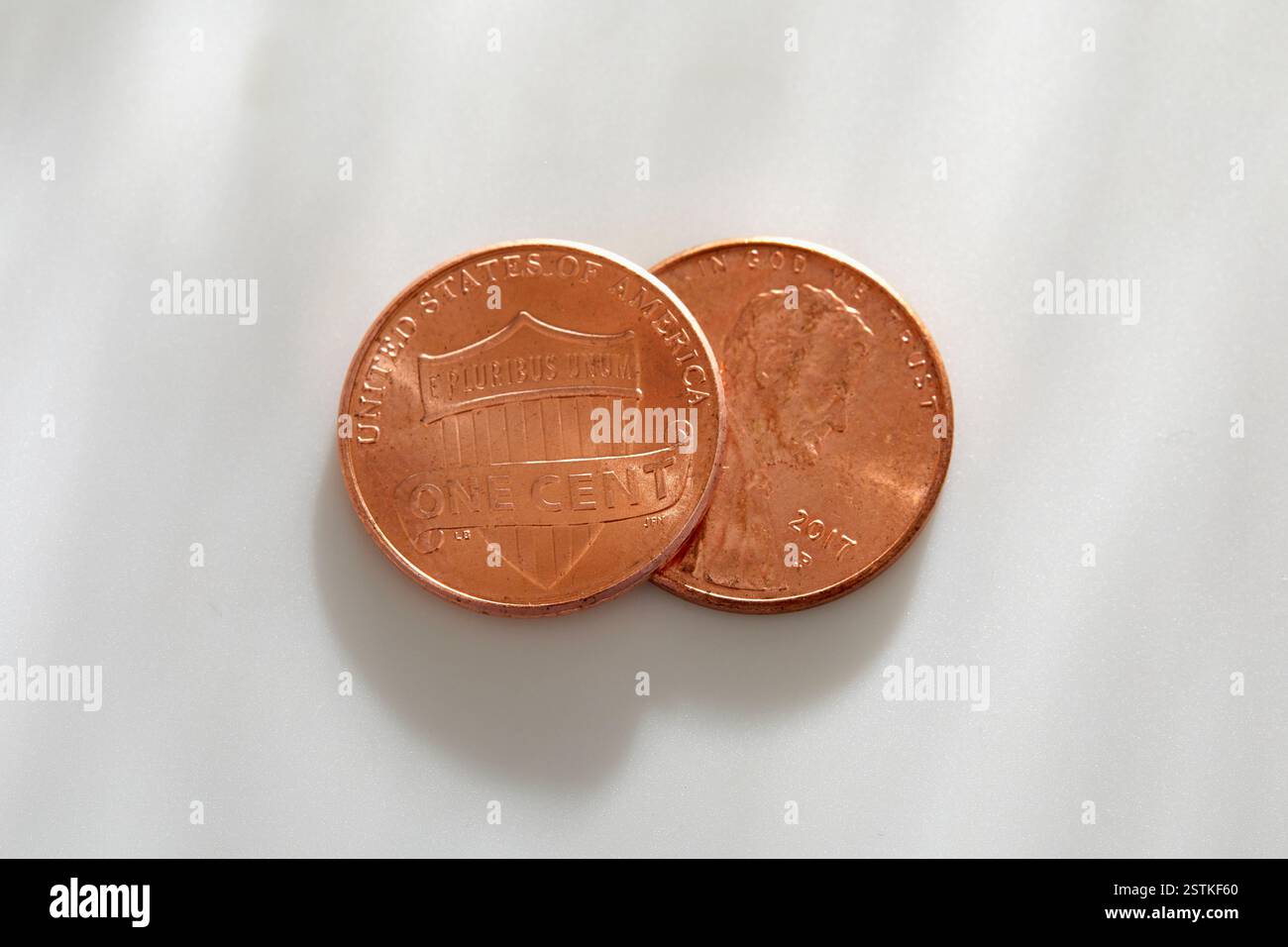 Two pennies on white background Stock Photo - Alamy