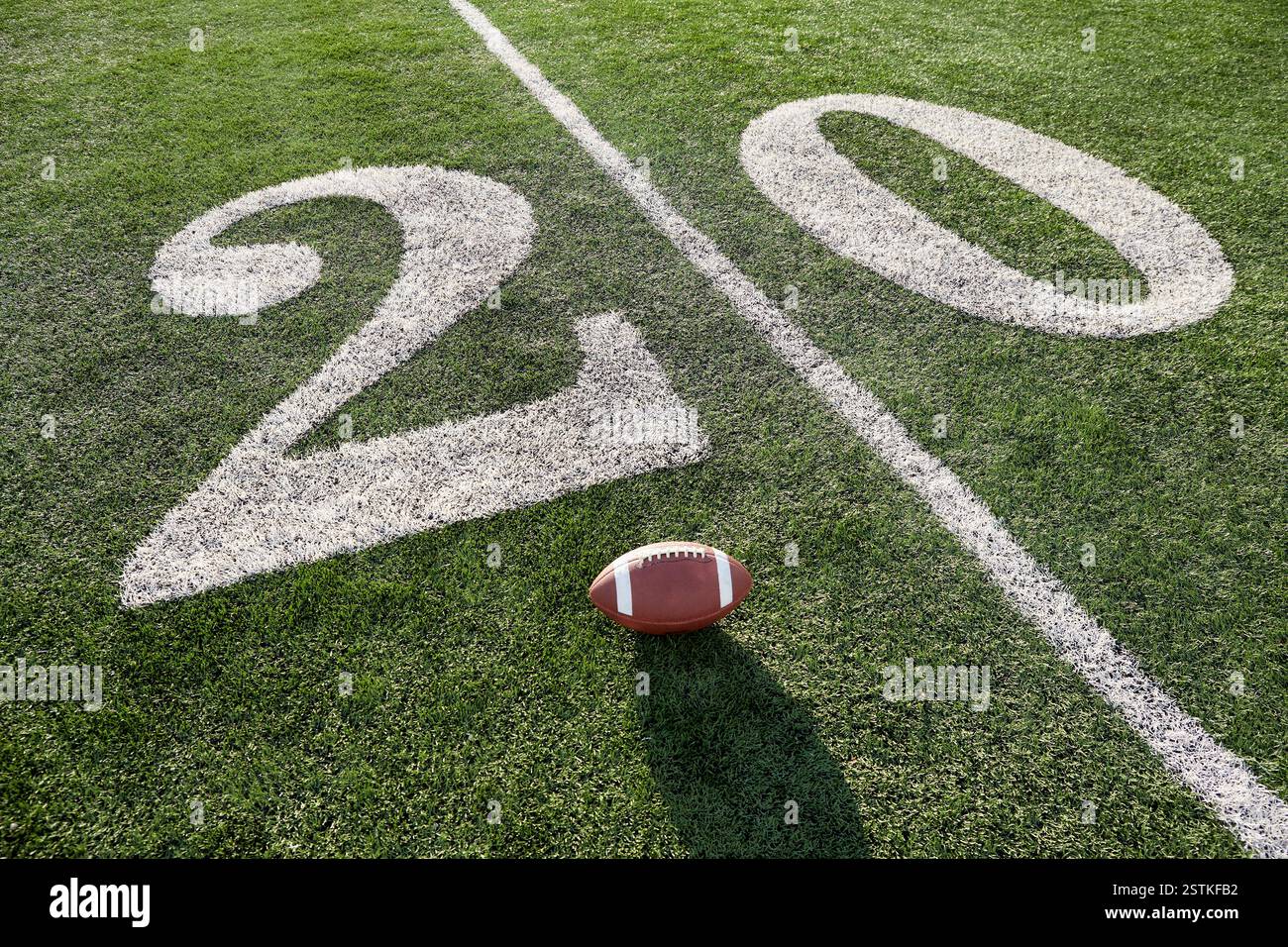 American football ball in field at 20 yard line Stock Photo - Alamy