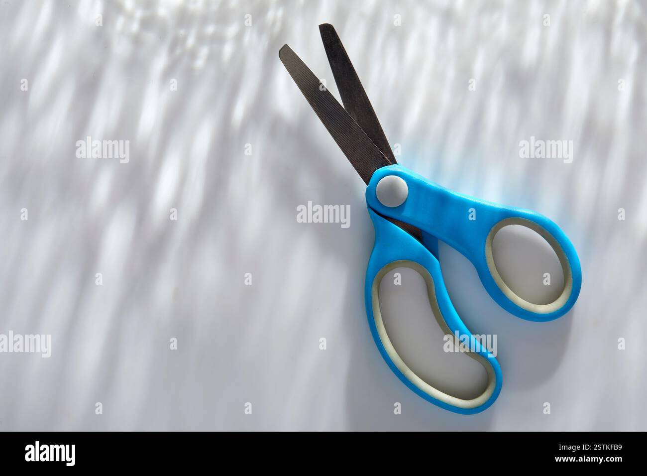 Blue children's scissors on white background Stock Photo - Alamy