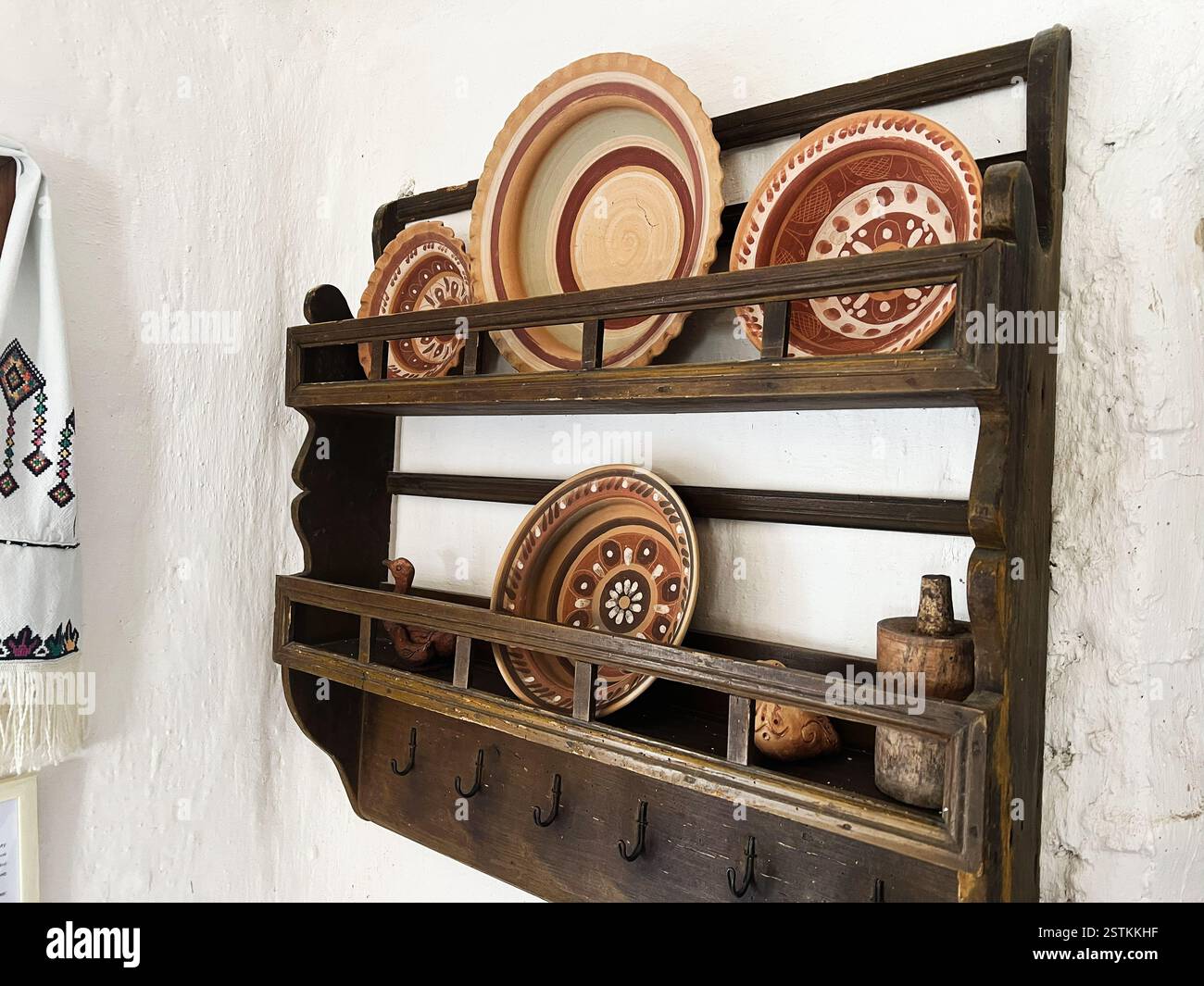 Clay plates on a vintage wooden shelf showcasing rustic craftsmanship ...