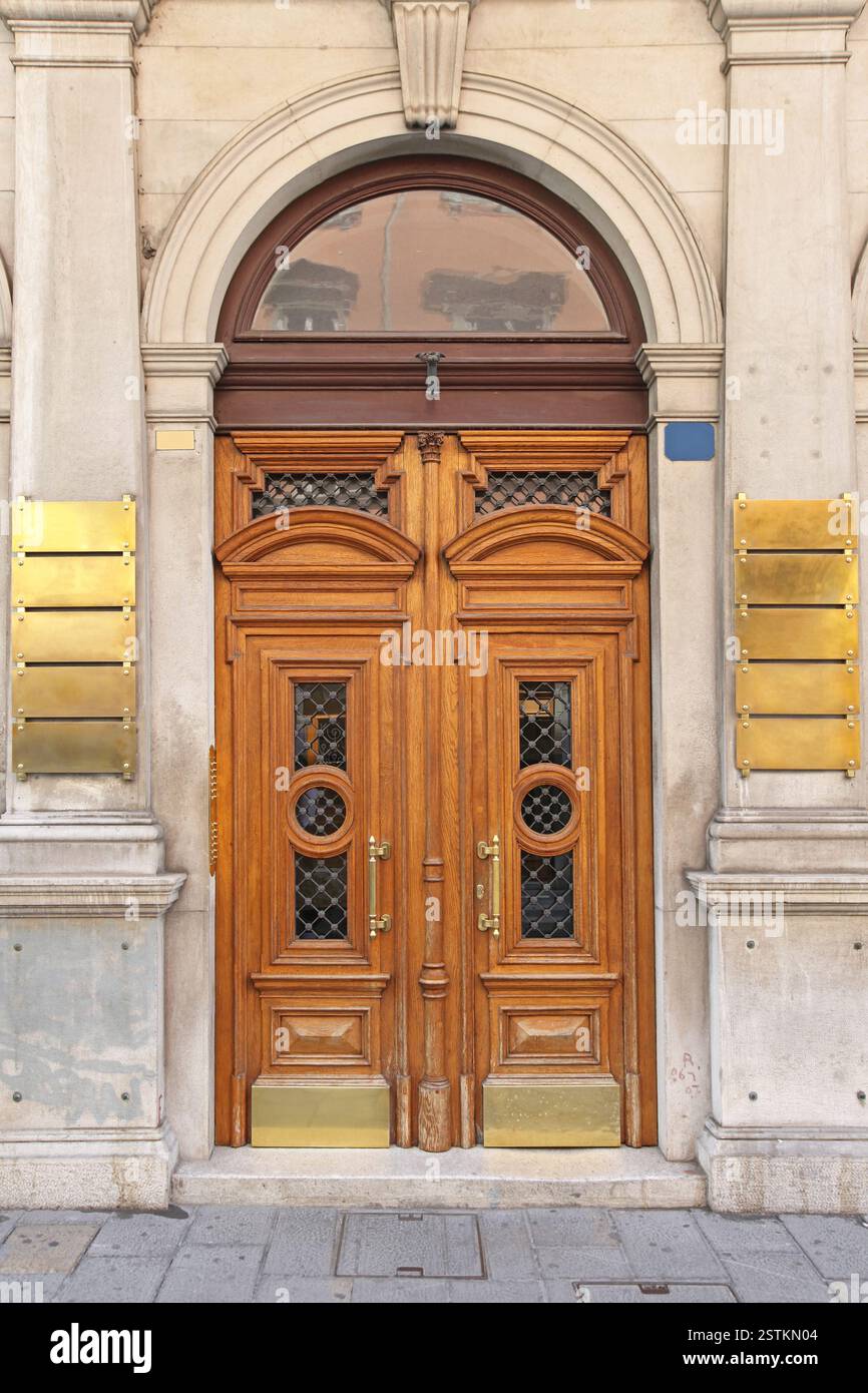Big Arch Double Wooden Doors in Trieste Stock Photo - Alamy