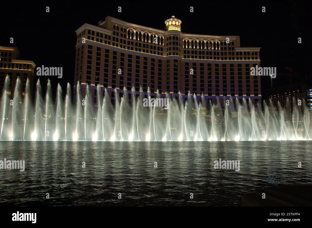 Nighttime scene at the iconic Bellagio Hotel in Las Vegas, with famous fountain show in full ...