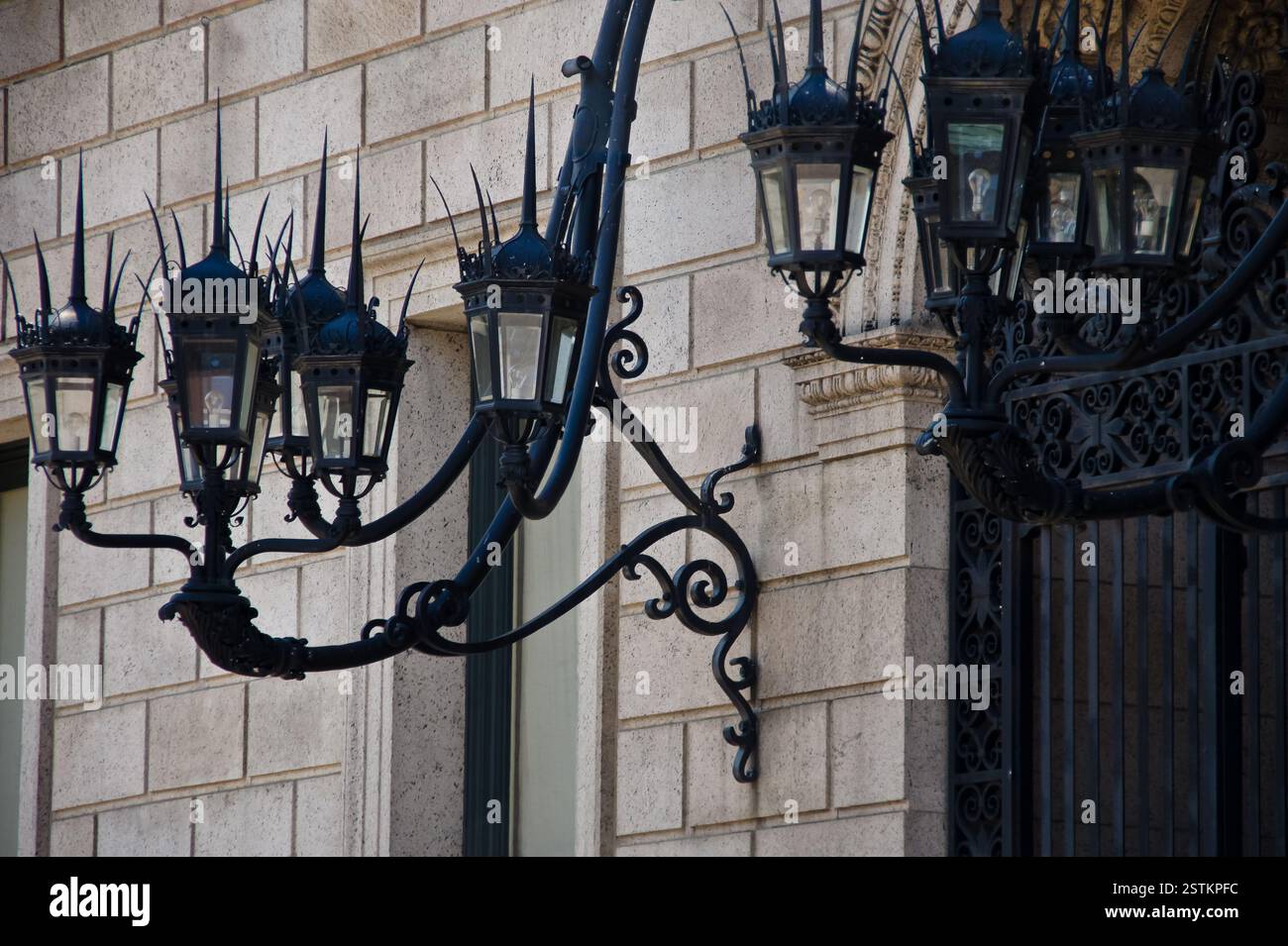 Wrought iron lamp with ornate design and multiple lights. Spikes and ...