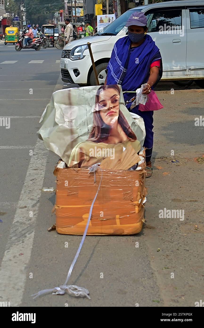 An employee of the municipality sweeps and collects garbage into a ...