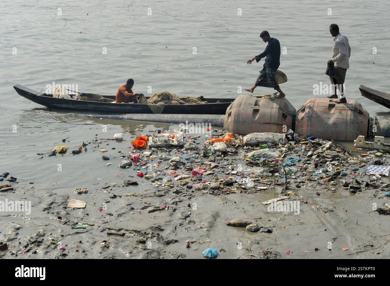 A fisherman’s boat rests on the banks of the polluted Karnaphuli River ...
