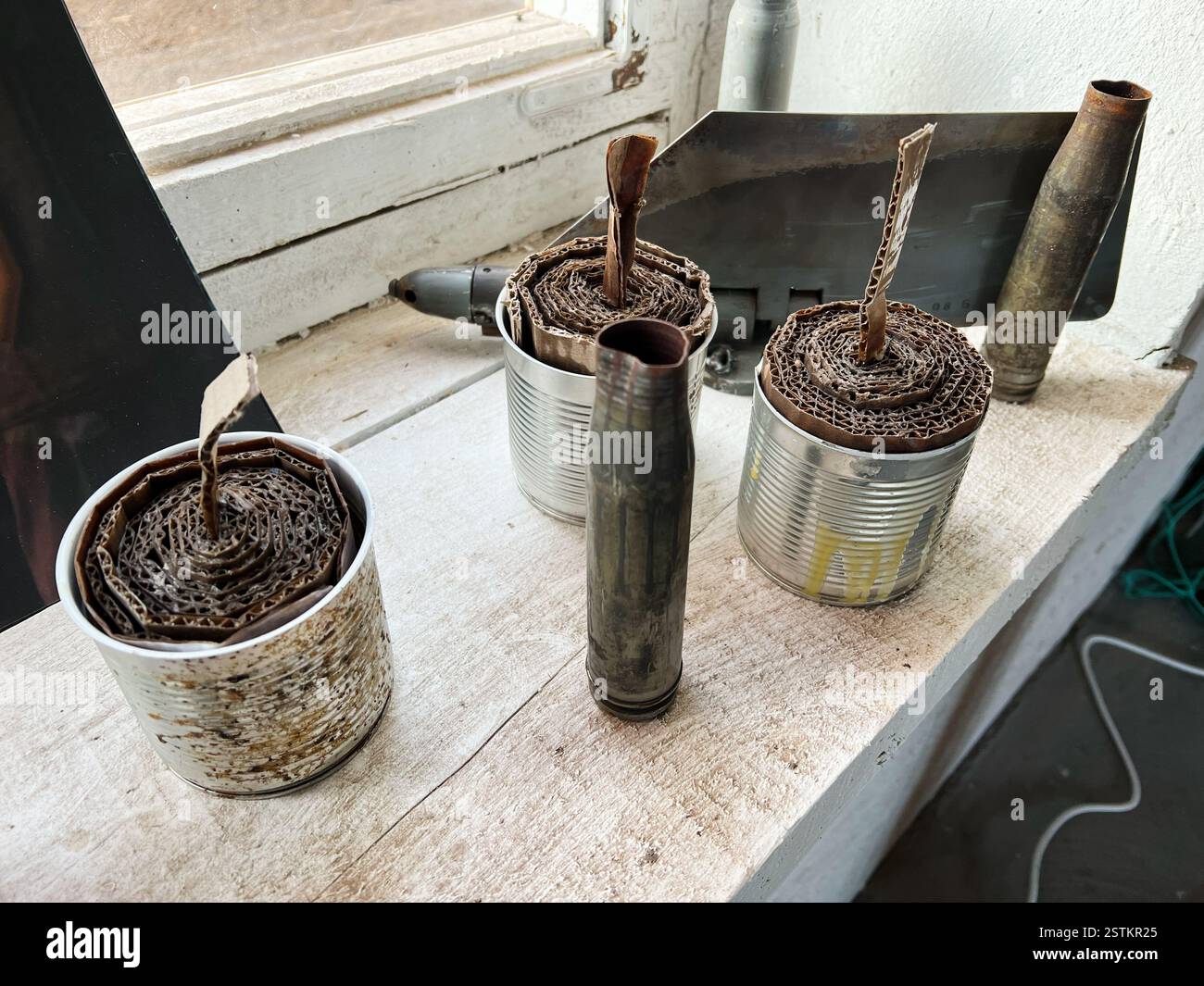 Tin cans repurposed into creative designs with rustic elements in a ...