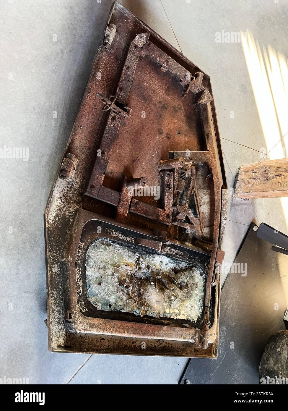 A rusty door of military car featuring splintered glass and exposed ...