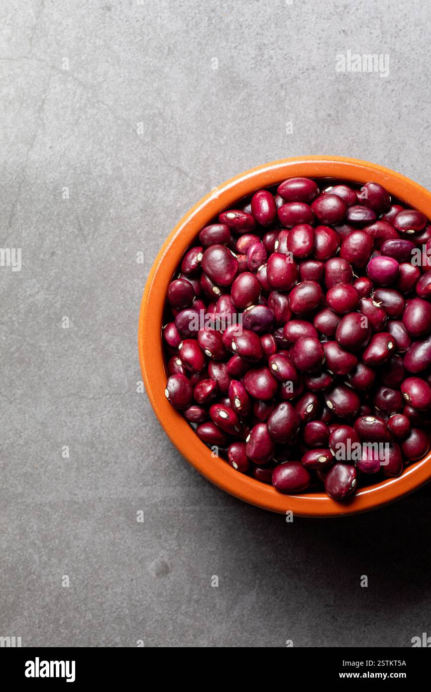 Earthenware bowl full of red beans from Anguiano on a kitchen worktop ...