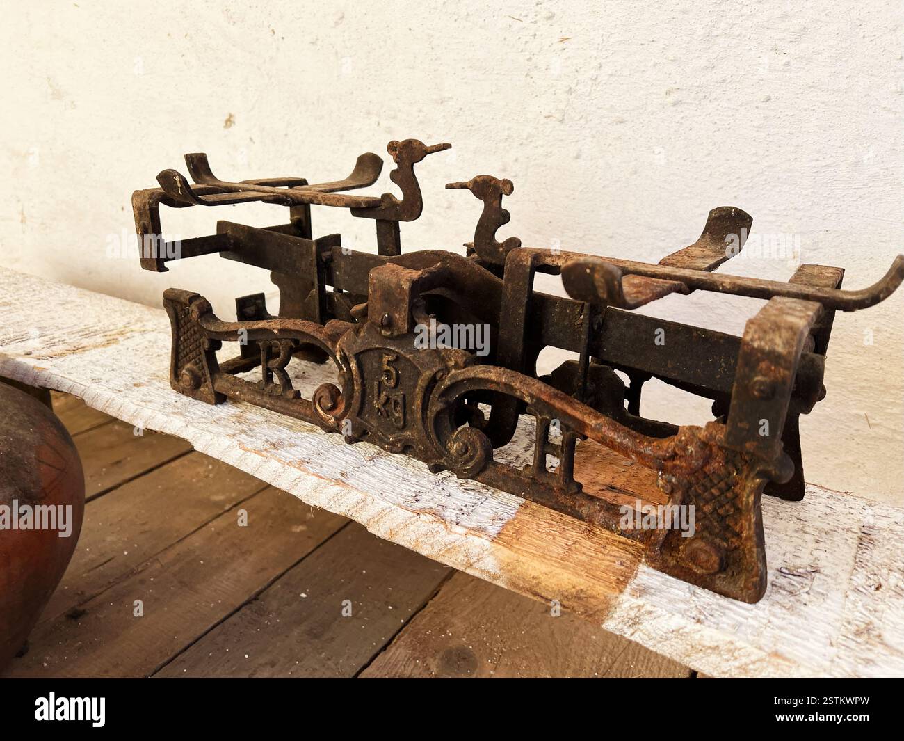 Vintage mechanical scale placed on wooden platform, highlighting its ...
