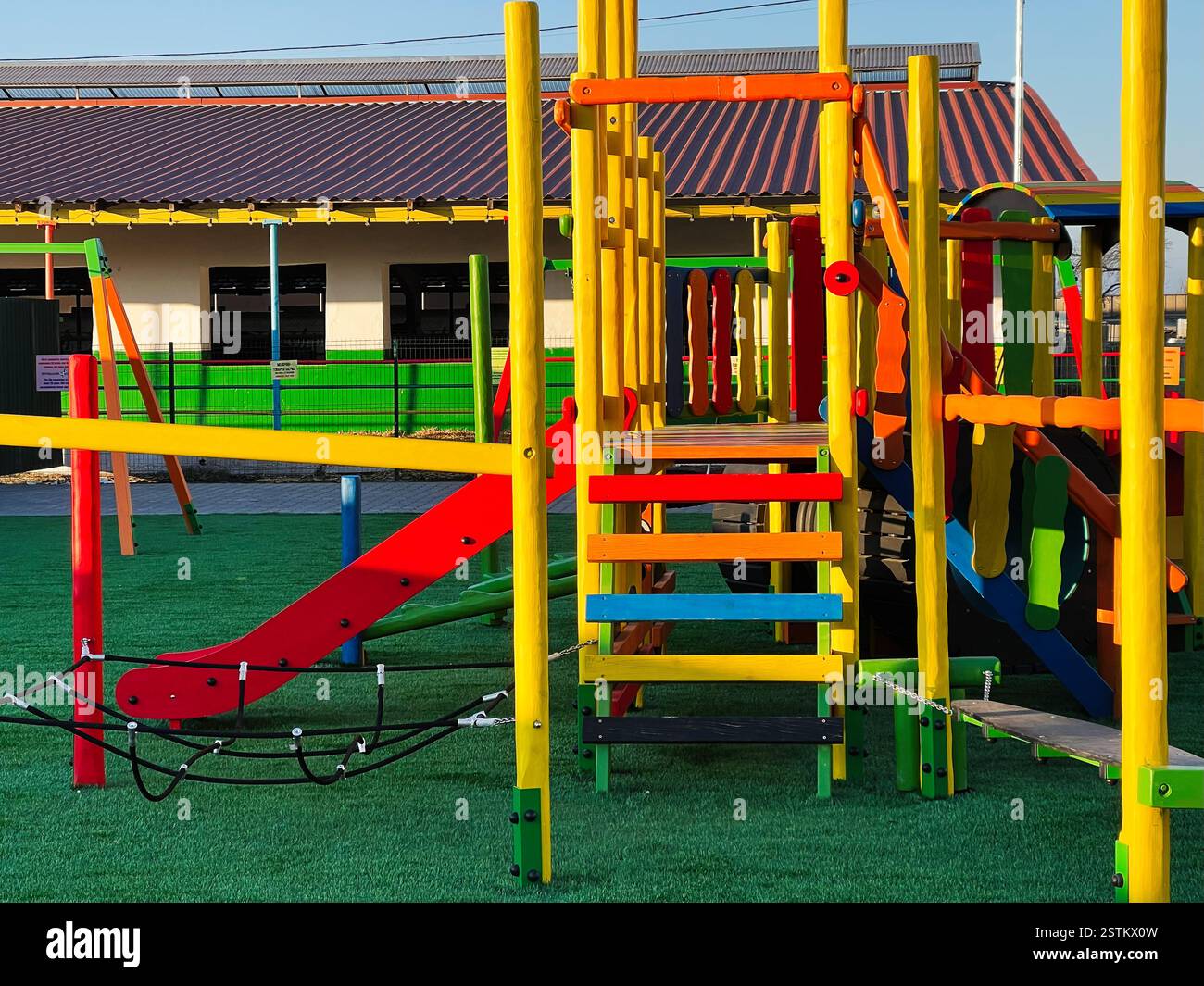 Vibrant wooden play structures in a children’s outdoor recreational ...