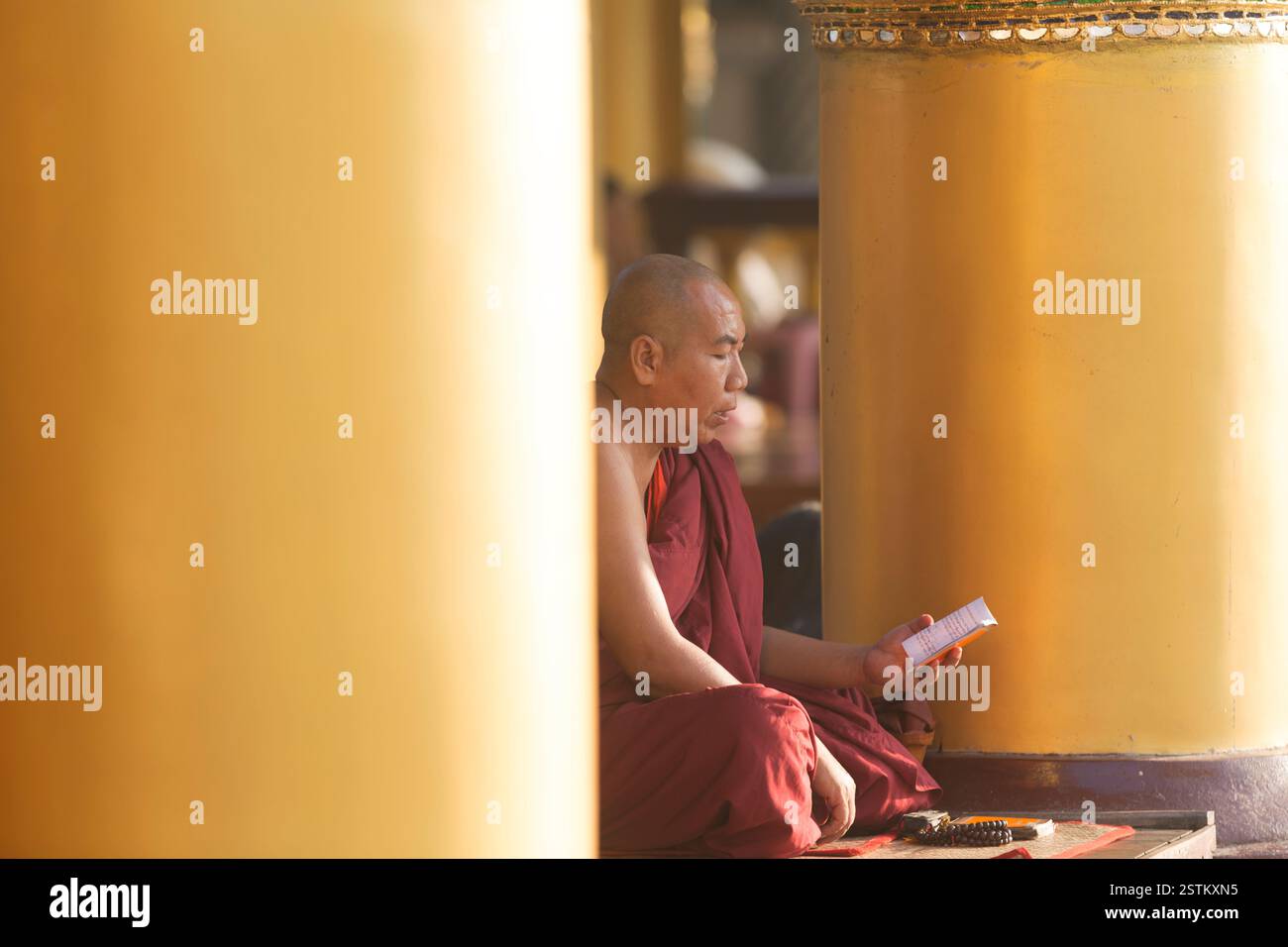 Myanmar, Yangon, a monk in prayer at the Shwedagon Pagoda Stock Photo ...