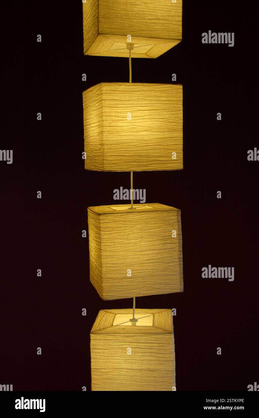 Minimalist ceiling pendant light with four cube-shaped units, connected ...