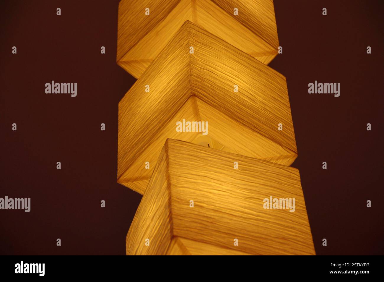 Minimalist ceiling pendant light with four cube-shaped units, connected ...