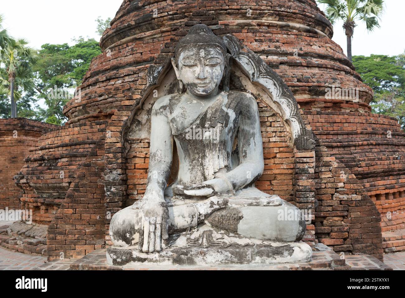 Myanmar, Mandalay, Stone Buddha statue in red brick stupa at the Yadana ...