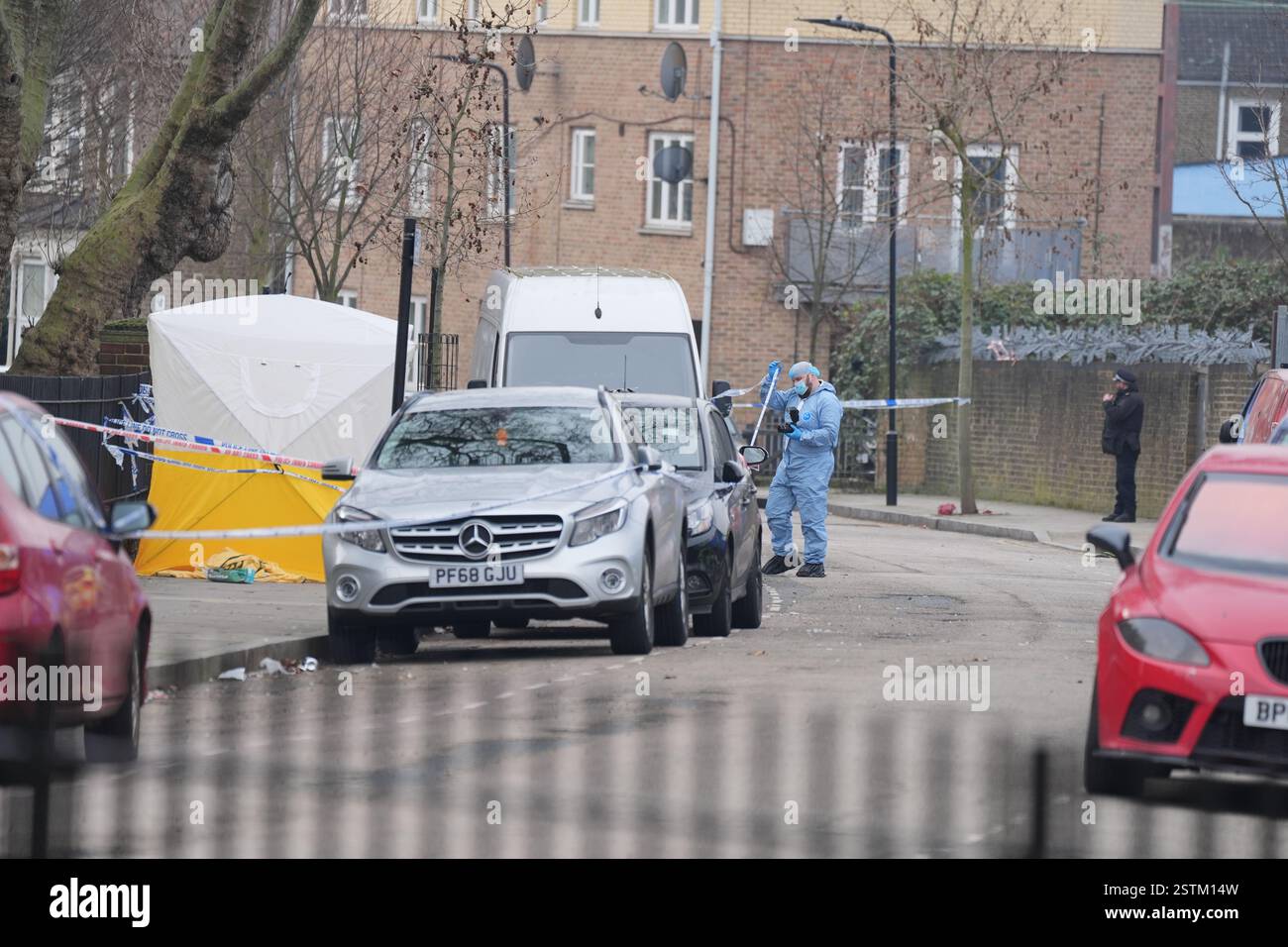 Police at the scene on Bodney Road in Hackney, east London, after the murder of a 20-year-old ...