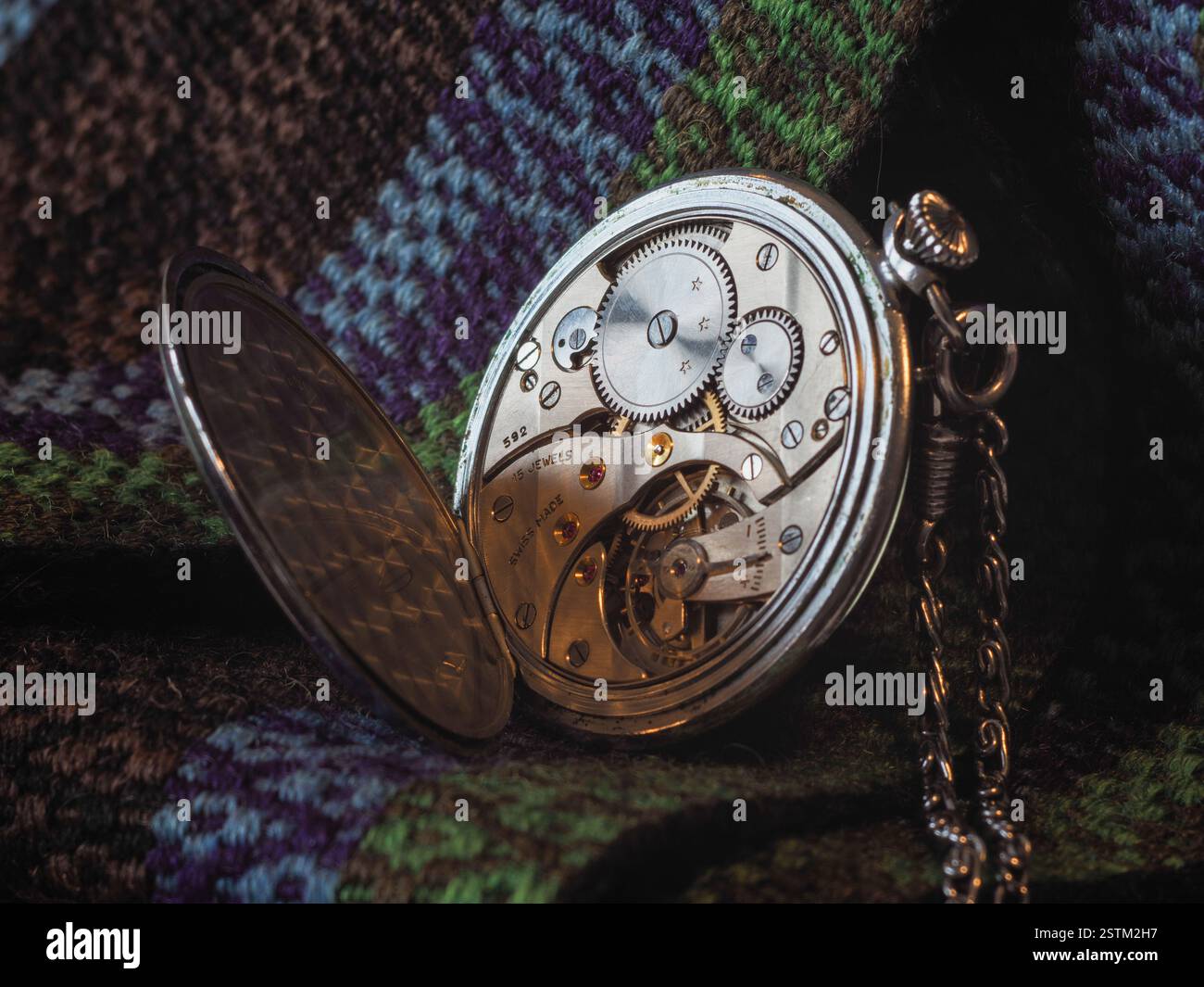 Vintage pocket watch with open clockwork mechanism and exposed gears on ...